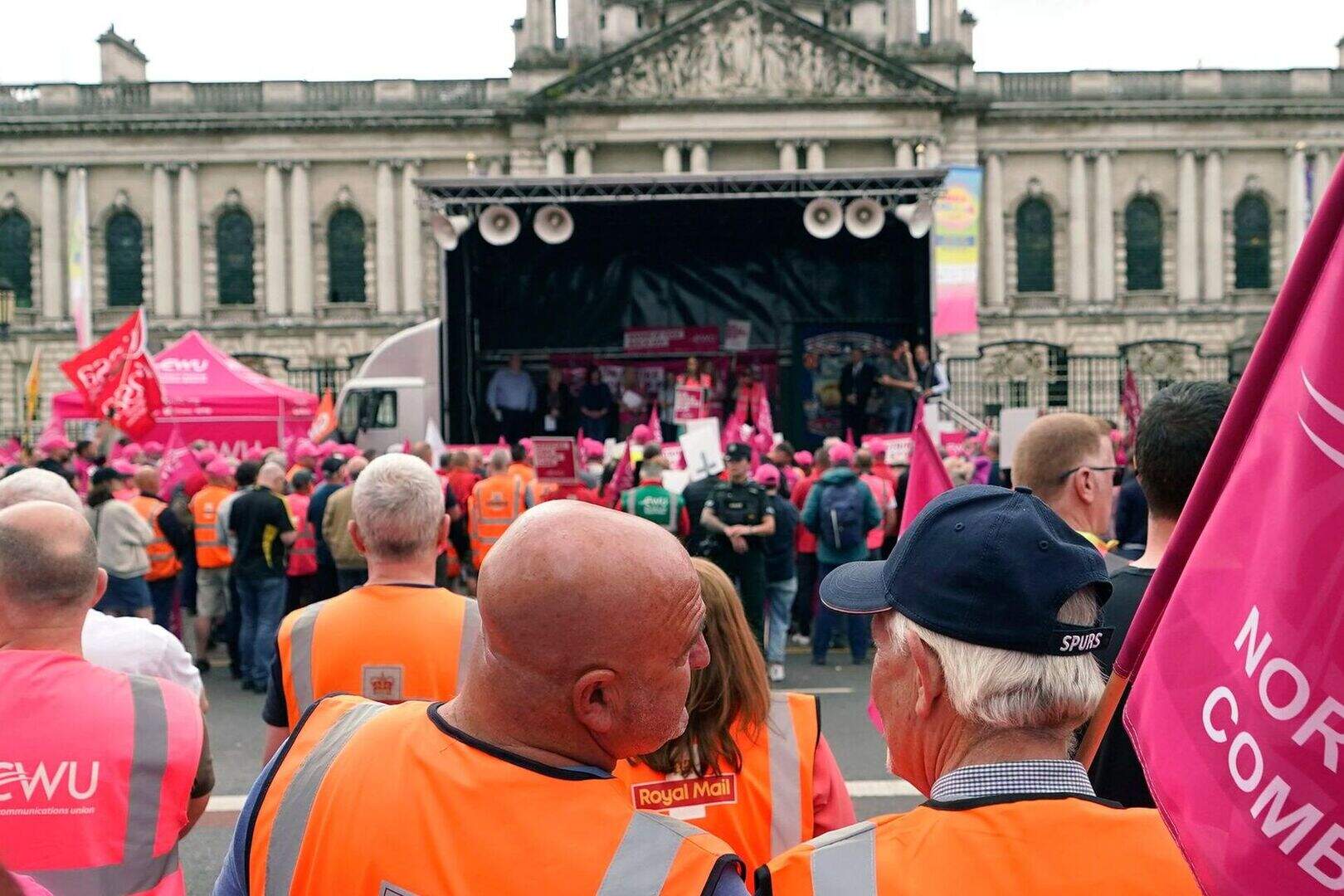 Angry postal staff join other workers at Belfast City Hall to protest ...