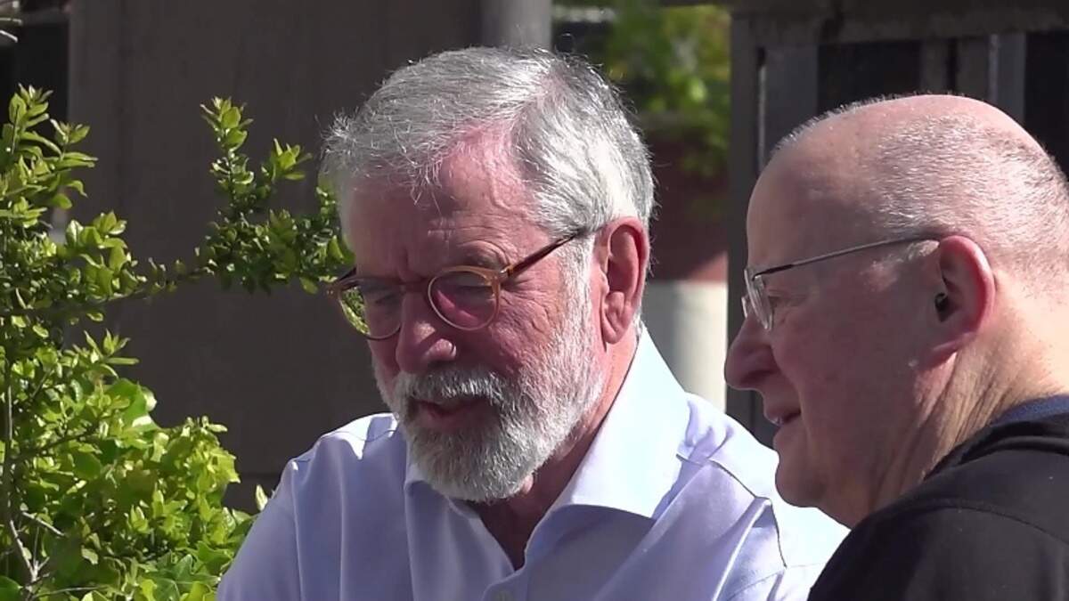 Gerry Adams speaks with Christy Moore outside Dublin's High Court ...