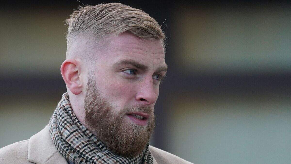 Assault charge footballer tells court he hopped over fan to protect ...