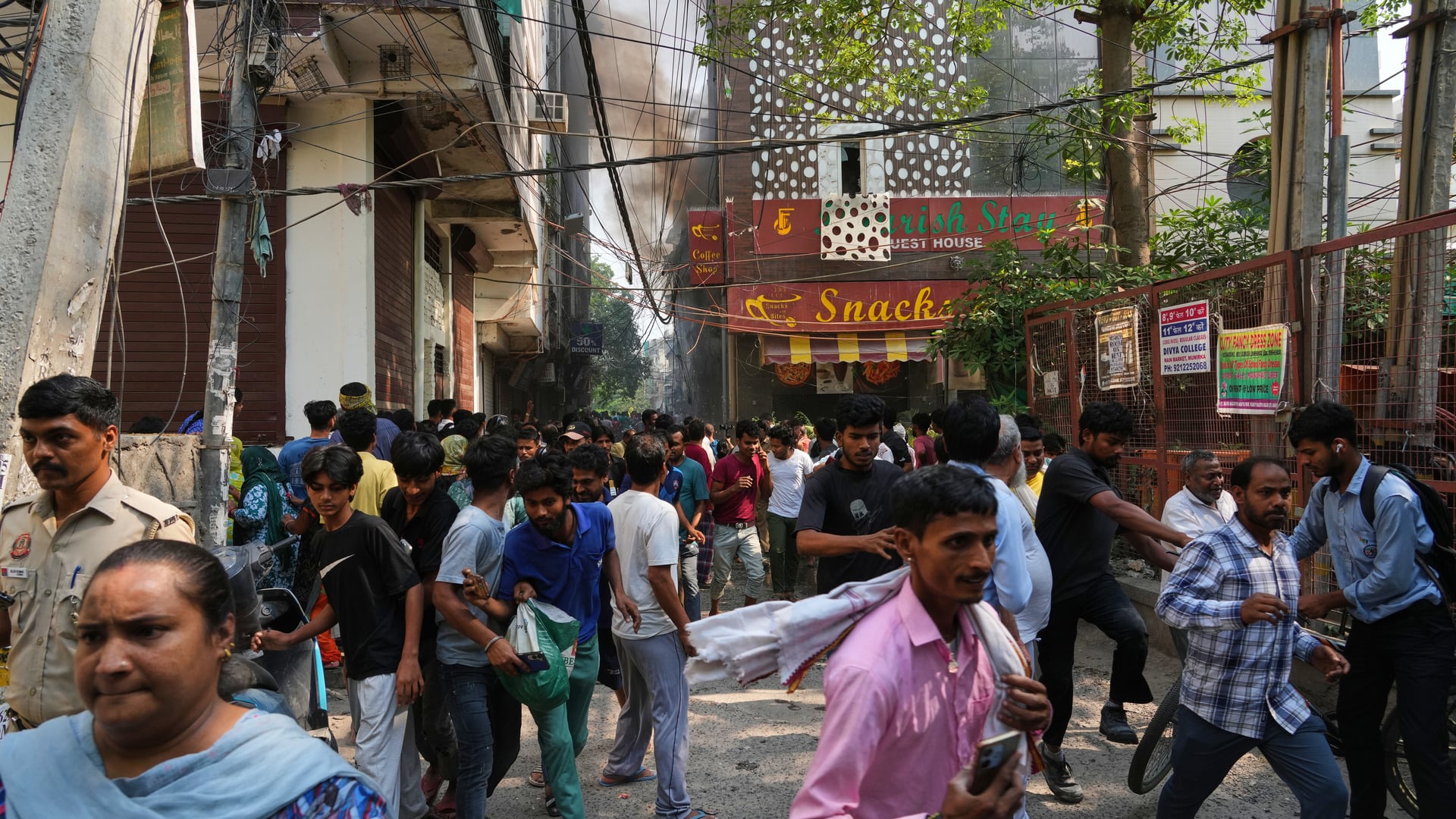 At least 18 people killed as fire sweeps through building in New Delhi ...